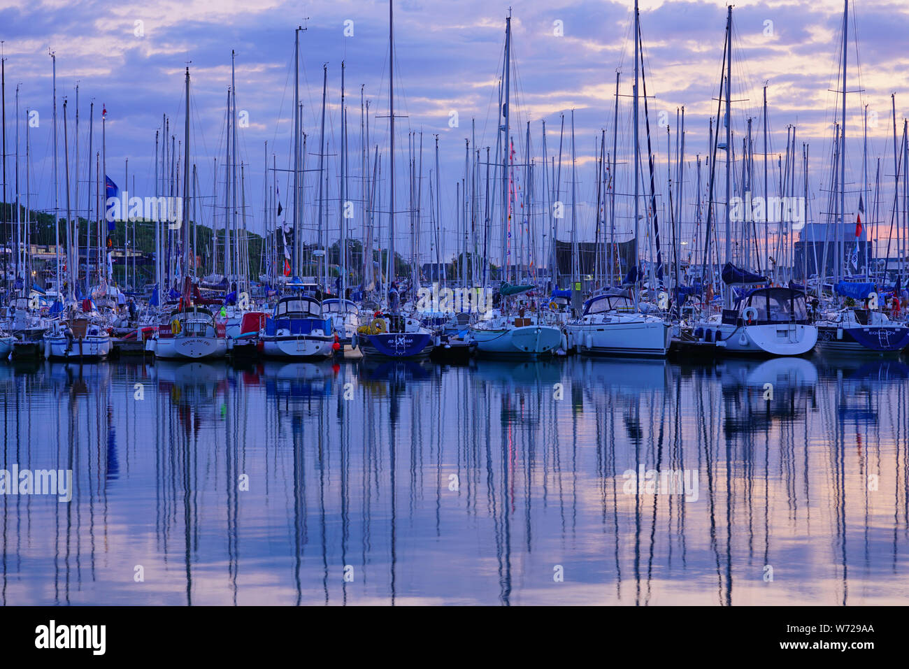 HOWTH, IRELAND- 27 JUL 2019- Colorful sunset sky over boats in Howth, a ...