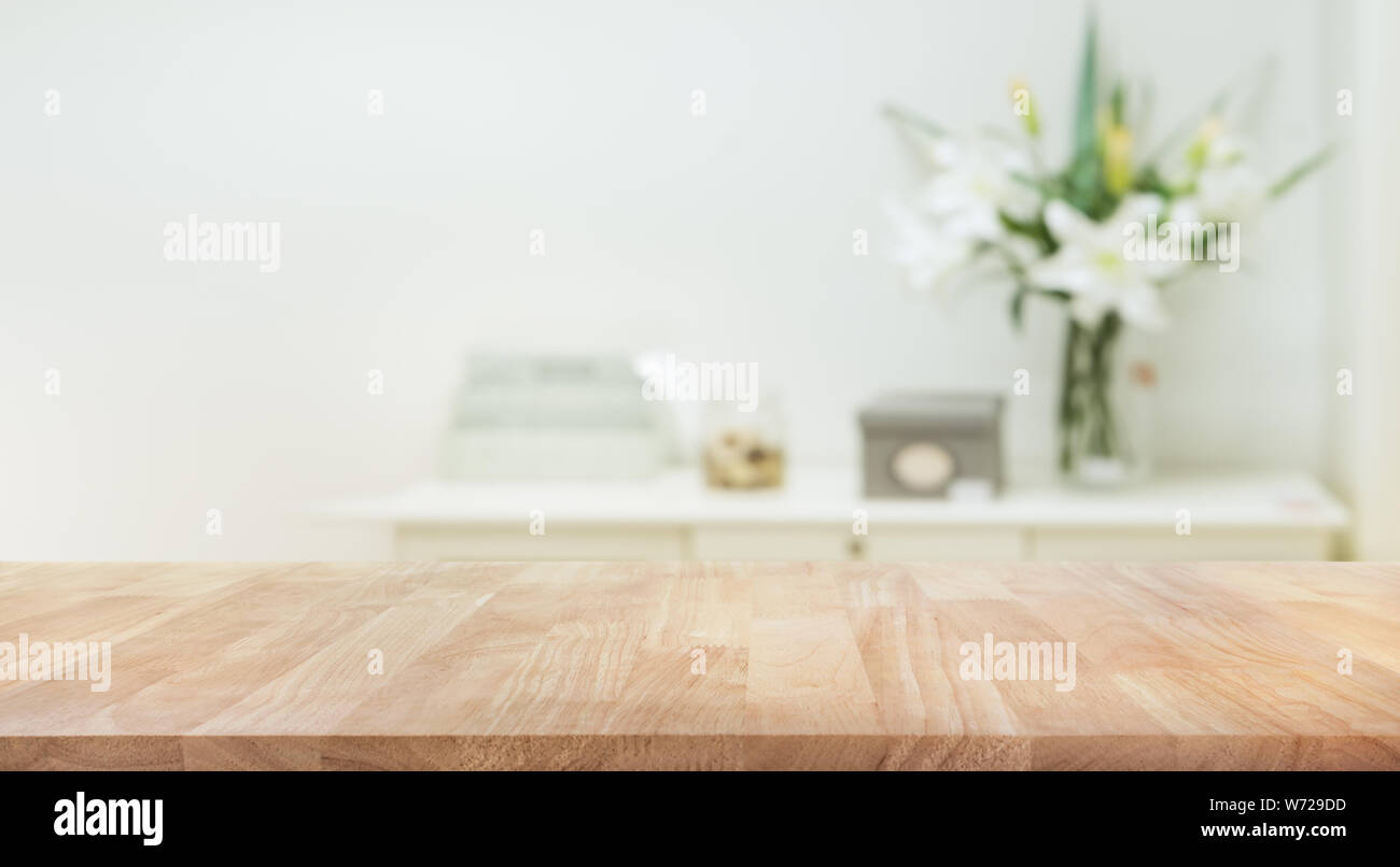 Real wood table top texture on white wall room background.For create ...