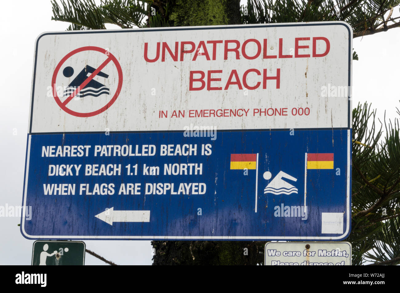 A beach guard warning sign. ‘Unpatrolled beach' at Moffat beach near ...