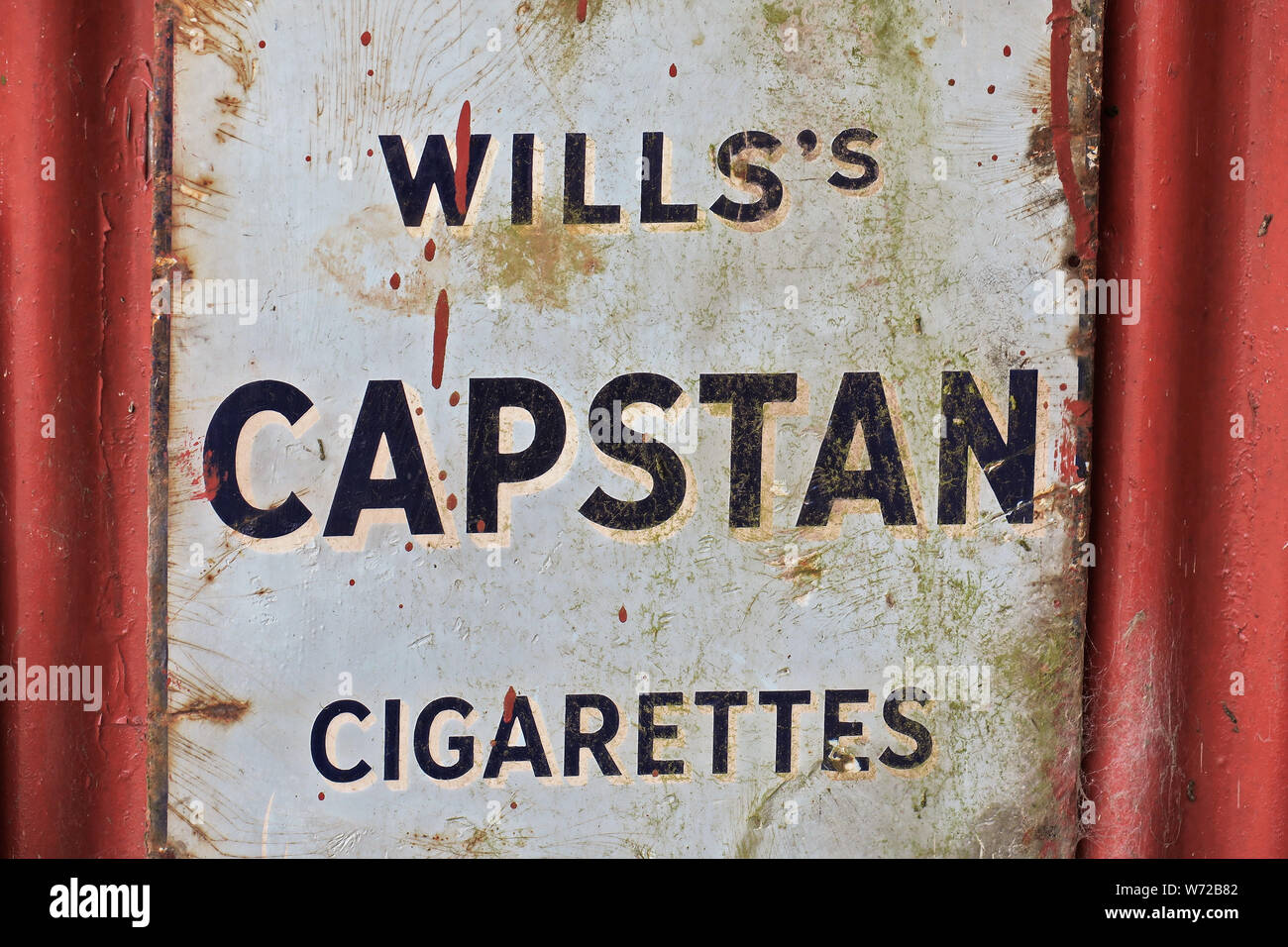 Enameled metal advertising boards or signs from a bygone era with ...