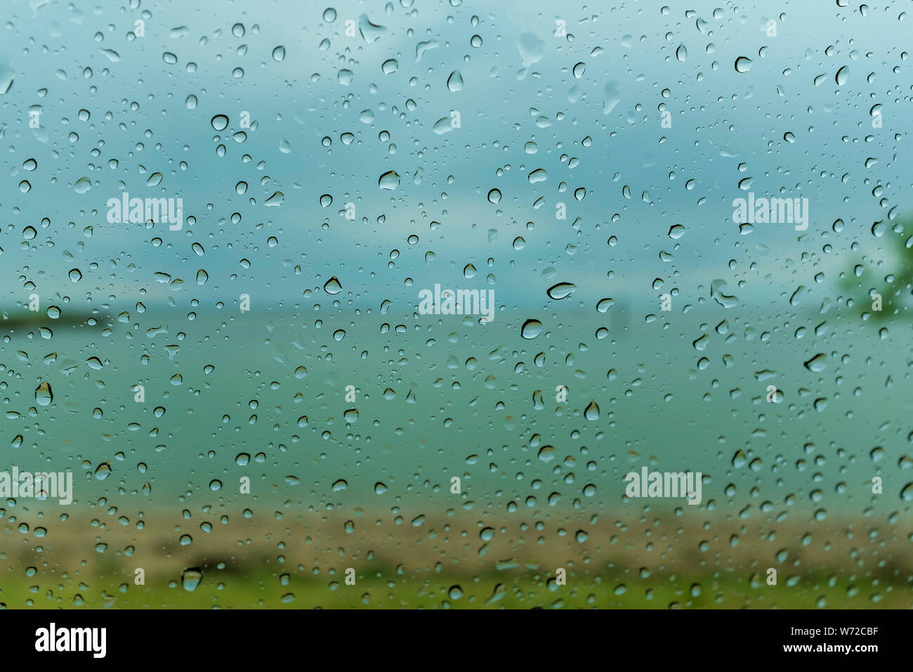 Rain drops and blurred landscape Stock Photo - Alamy