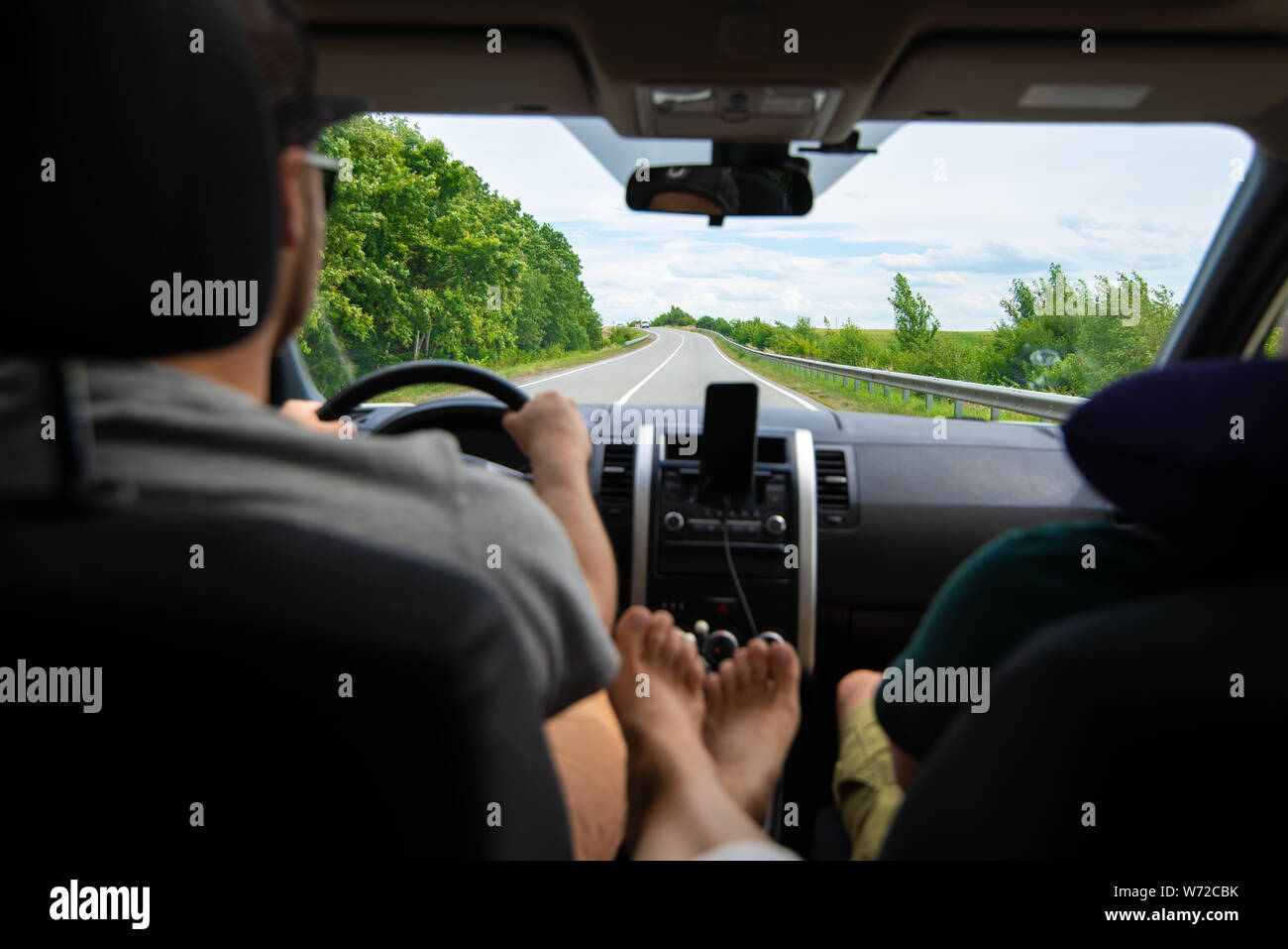 woman sitting at backseats of car put legs on armrest sunroof car ...