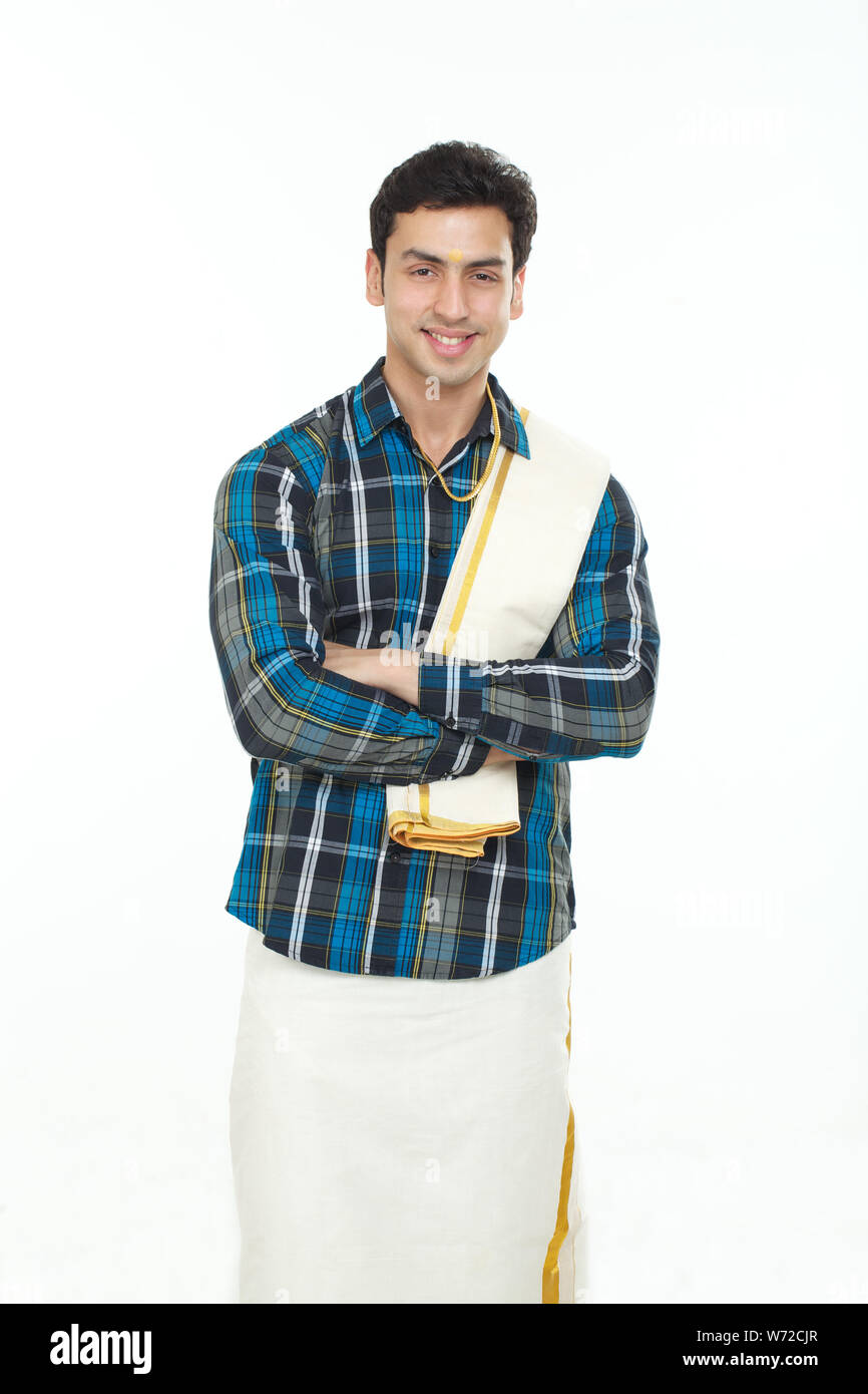 South Indian man smiling with his arms crossed Stock Photo - Alamy