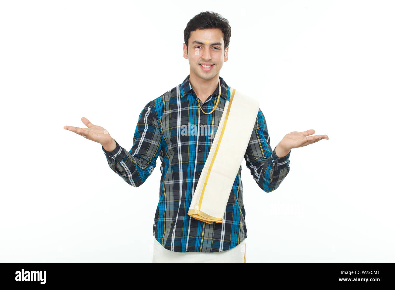 South Indian man smiling with his arm outstretched Stock Photo - Alamy
