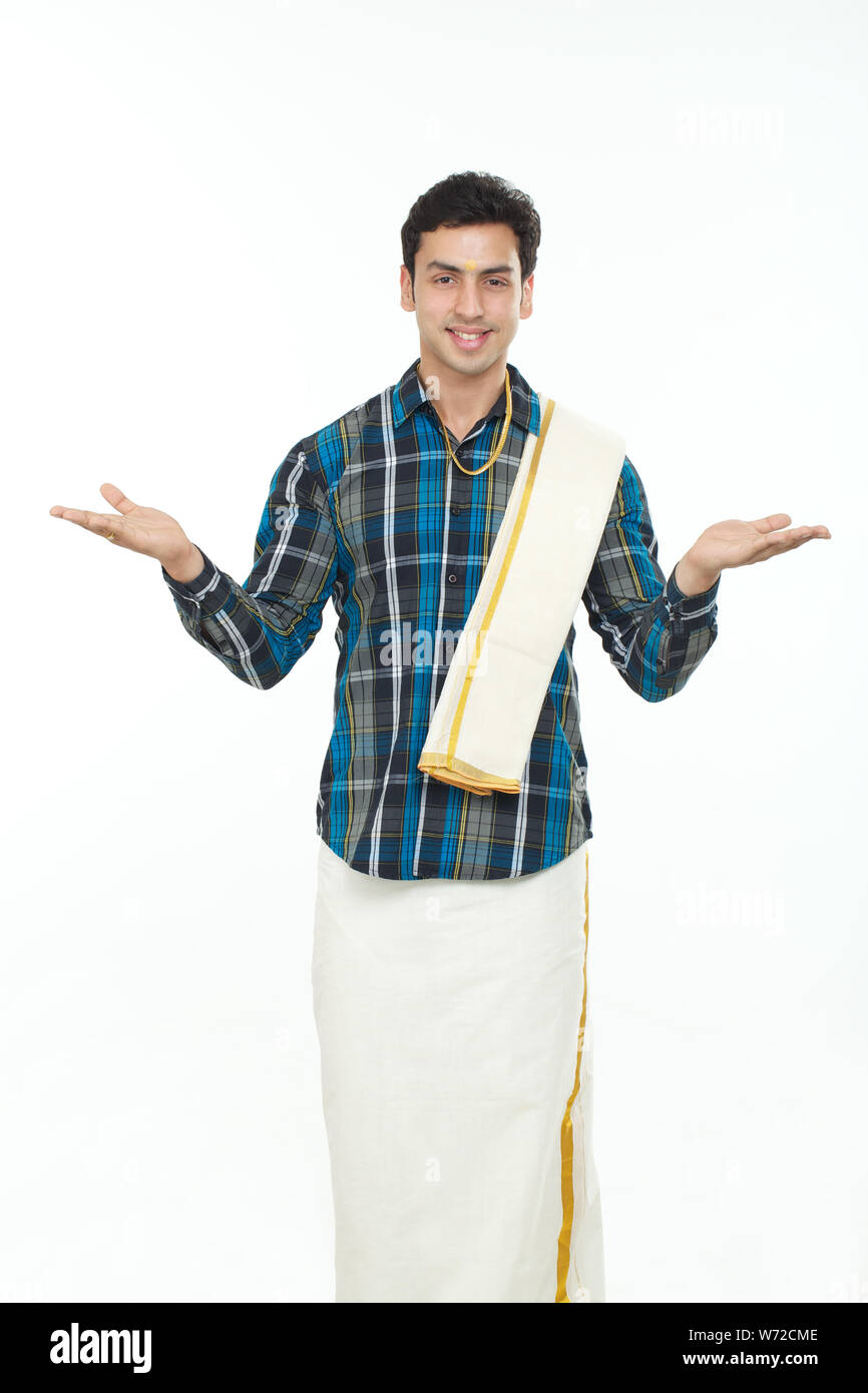 South Indian man smiling with his arm outstretched Stock Photo - Alamy