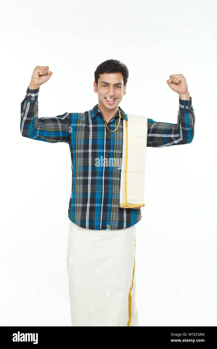 South Indian man smiling with his arm outstretched Stock Photo - Alamy