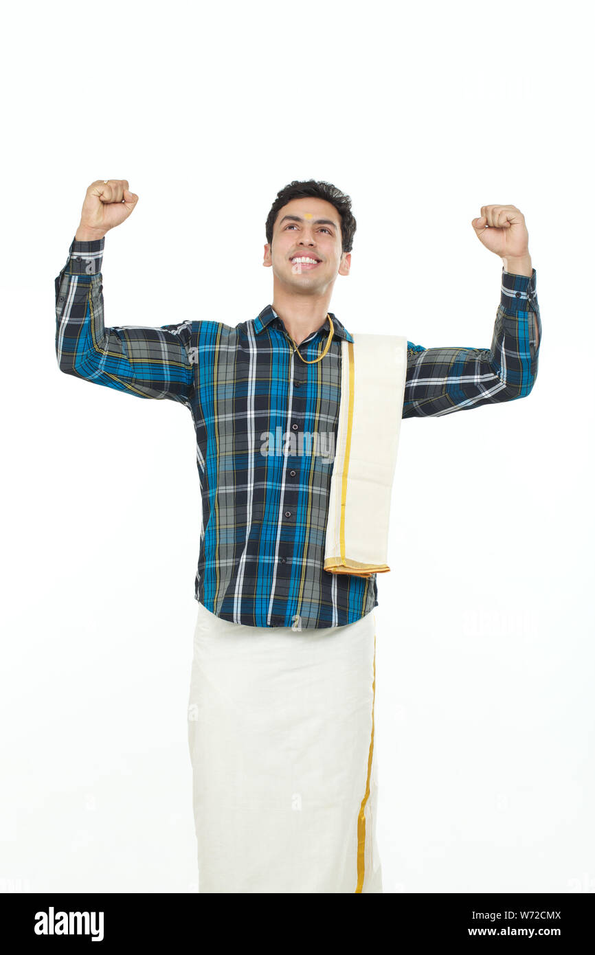 South Indian man smiling with his arm outstretched Stock Photo - Alamy