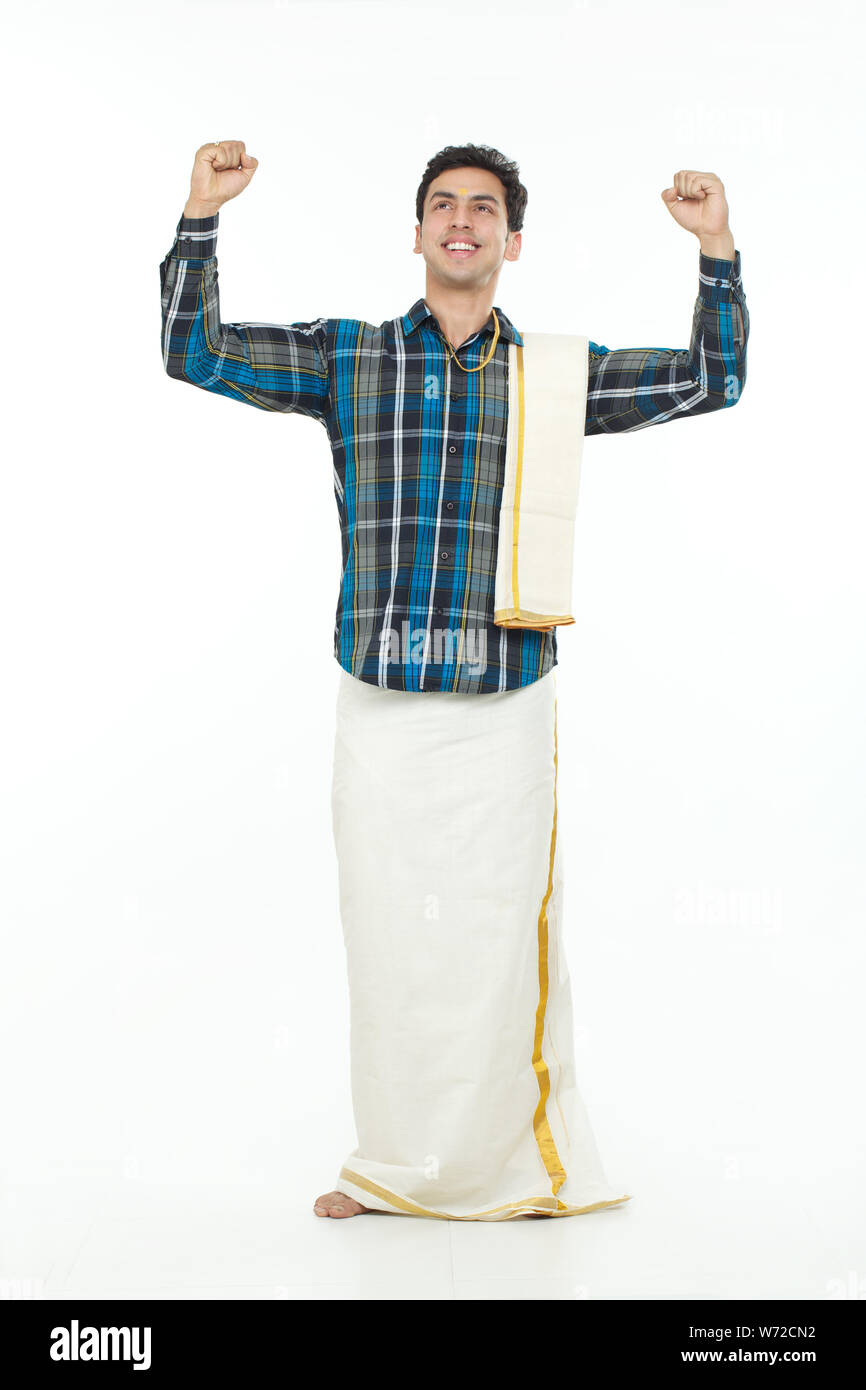 South Indian man smiling with his arm outstretched Stock Photo - Alamy