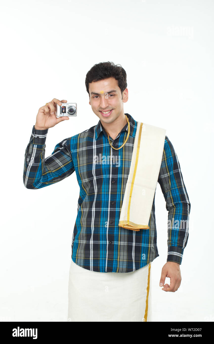 South Indian man taking picture with digital camera Stock Photo - Alamy