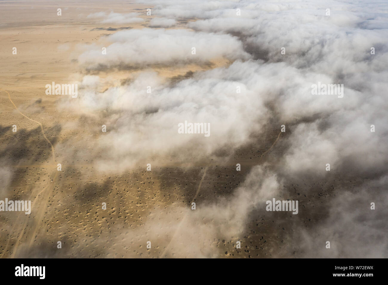 Coastal fog rolling over the desert landscape of Skeleton coast ...