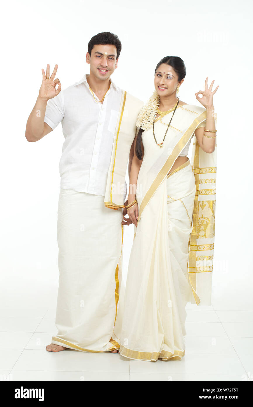 South Indian couple showing ok sign and smiling Stock Photo - Alamy
