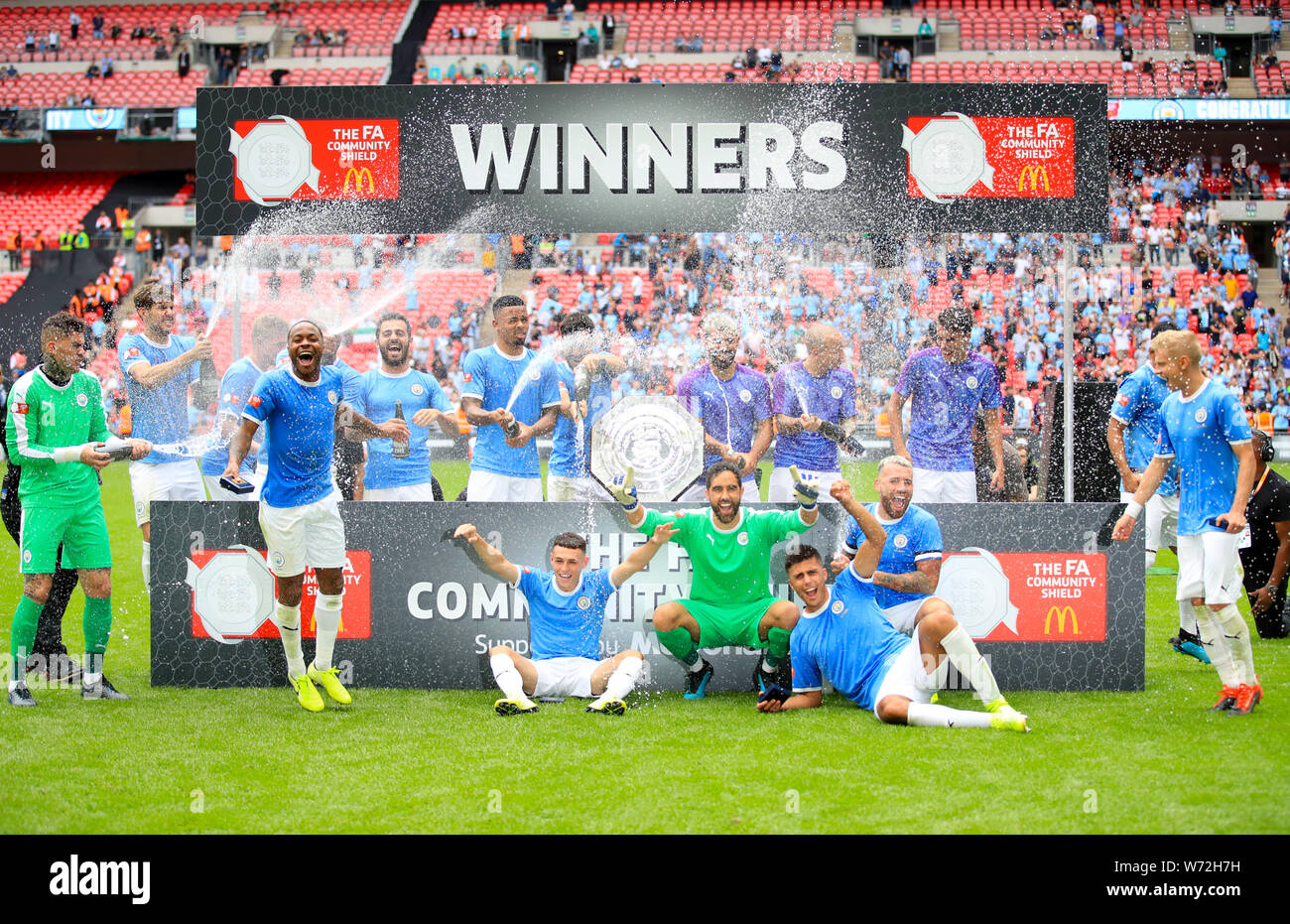 Manchester City players celebrate with the trophy after winning the ...
