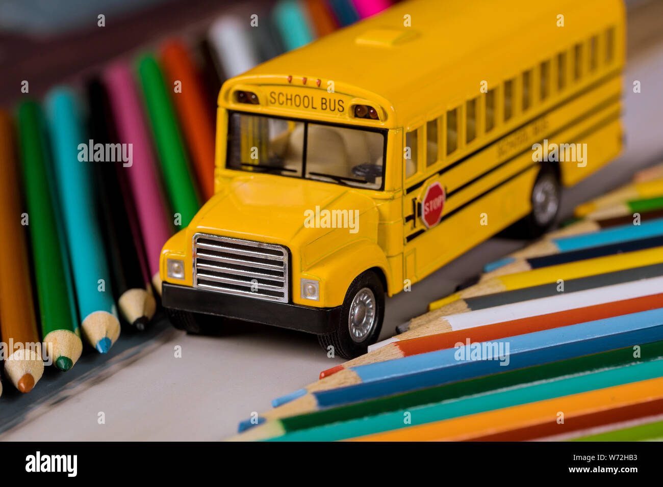 Back to school color pencils on light yellow school bus Stock Photo - Alamy