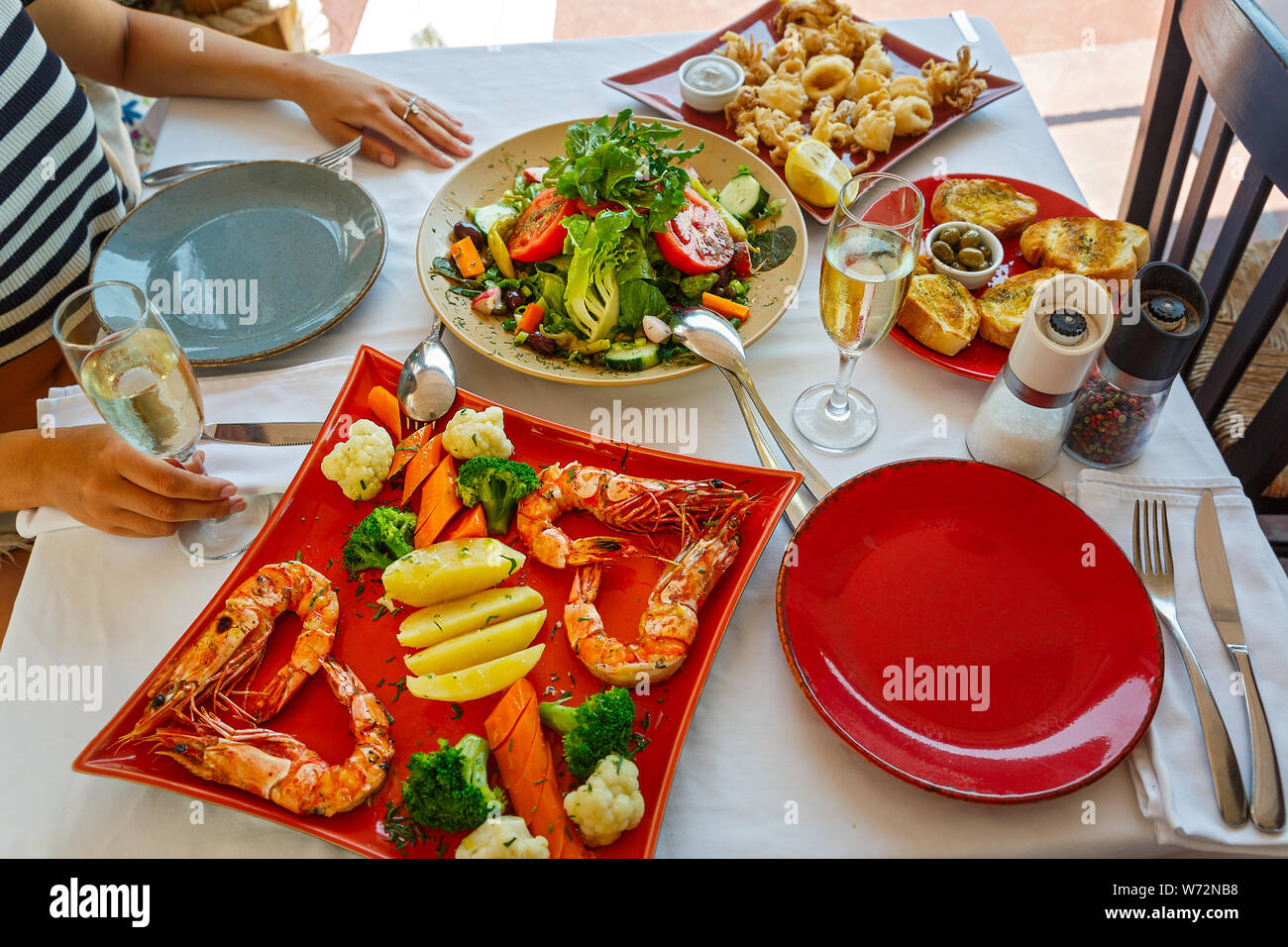 Dinner with seafood and vegetables at the fish restaurant Stock Photo ...