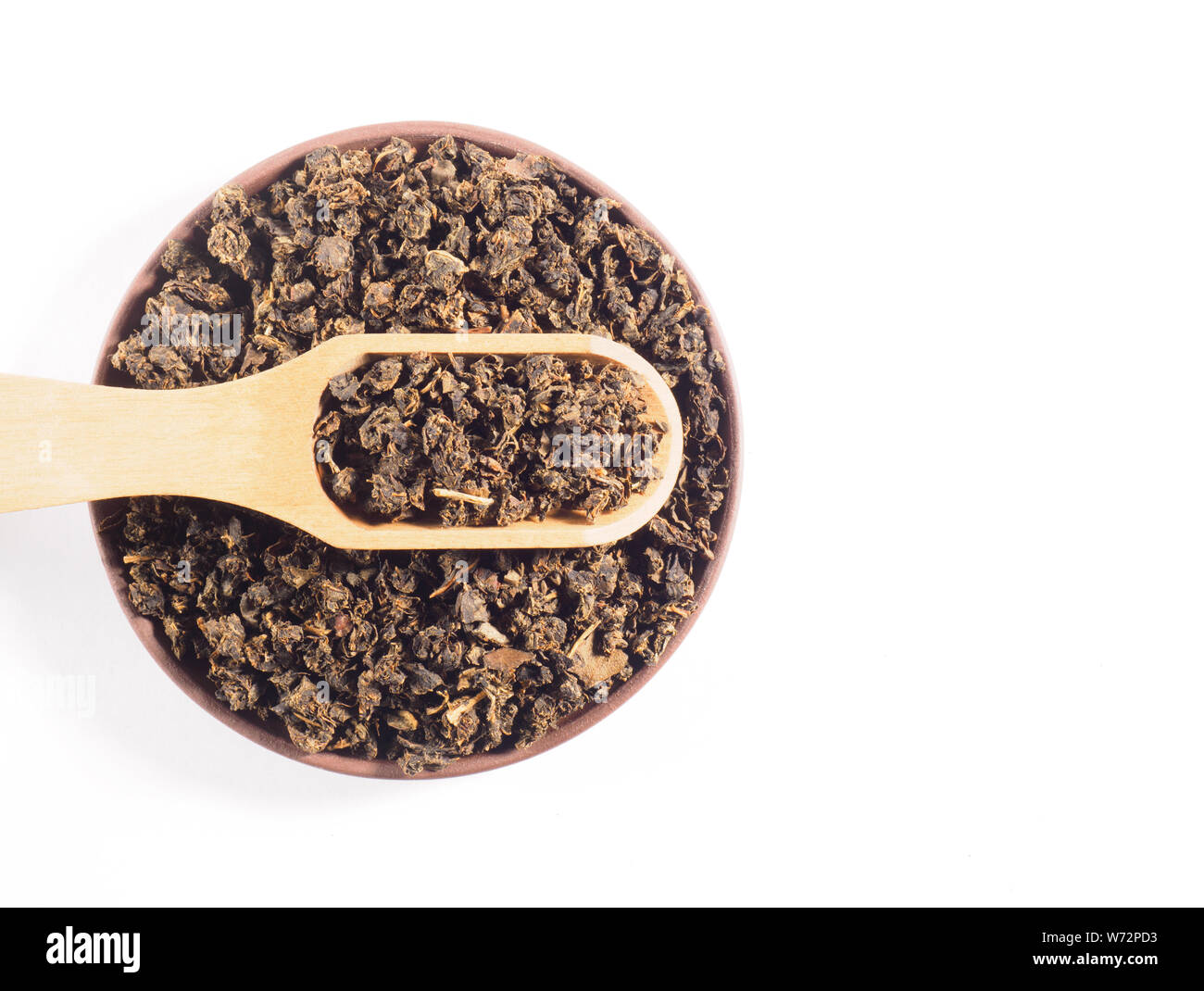 Fermented granular tea from Cherry (Cerasus) leaves on clay plate with ...