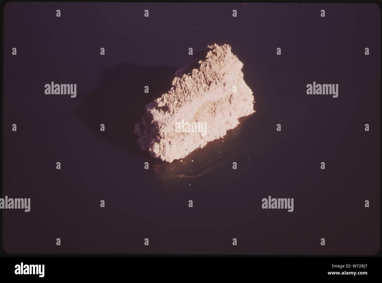 ONE OF THE ROCK FORMATIONS KNOWN AS THE PINNACLES THRUSTS UP FROM ...