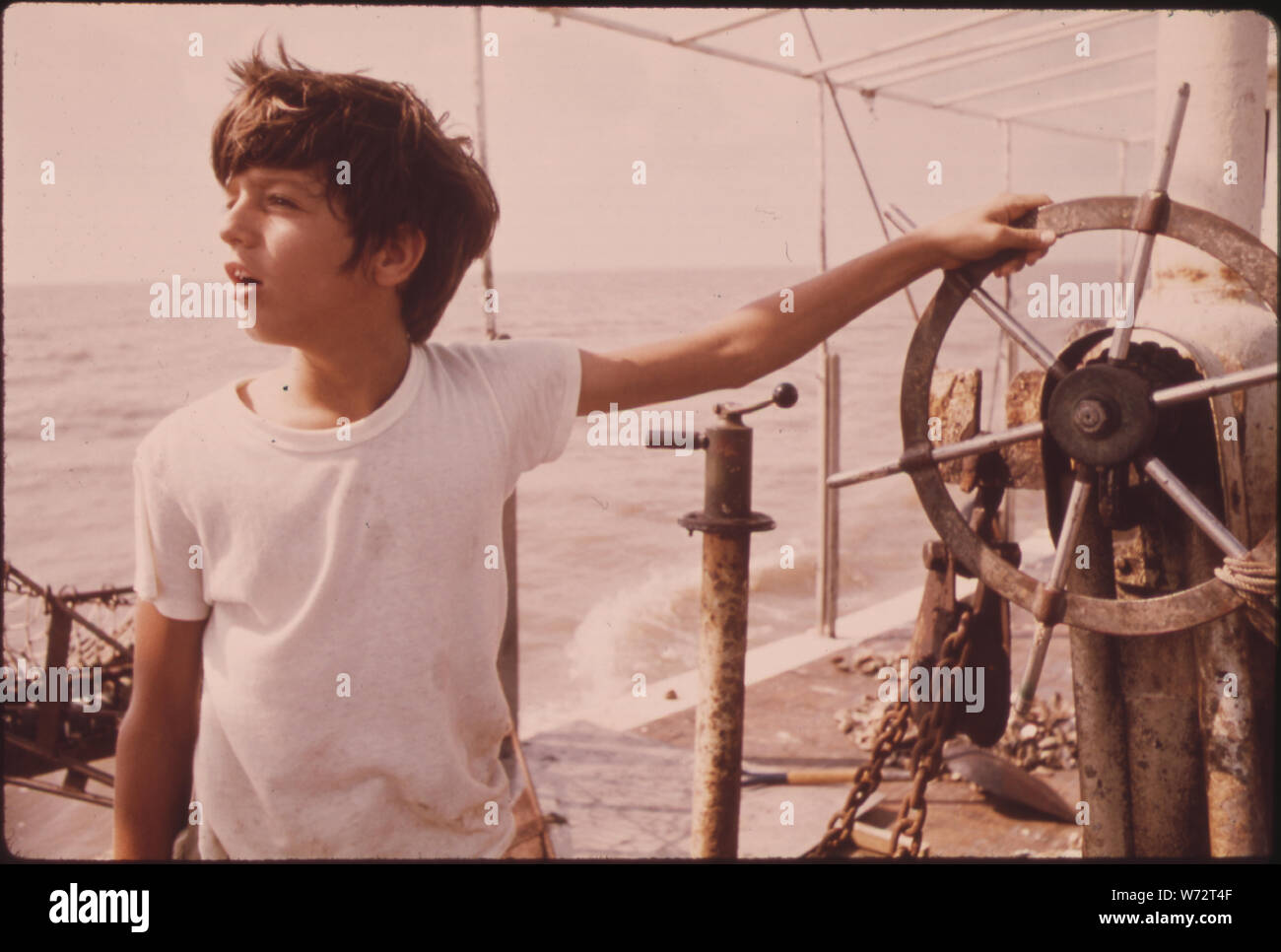 OYSTERMAN PETE TESVICH'S SON STANDS BY THE SHIP'S WHEEL ON HIS FATHER'S ...