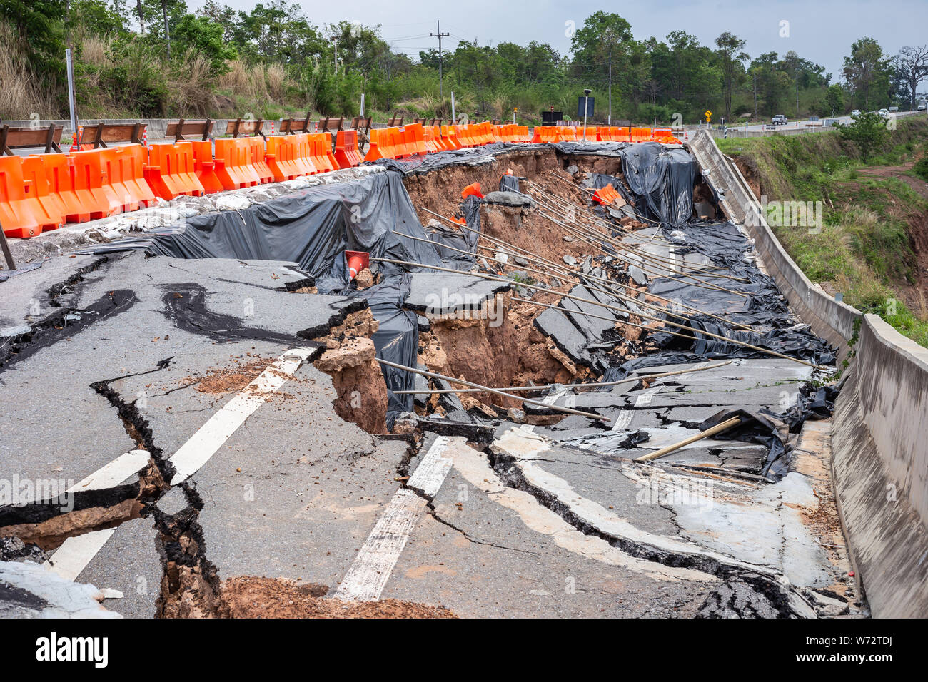 Big damage of asphalt road on the hillside cause of heavy rain and ...