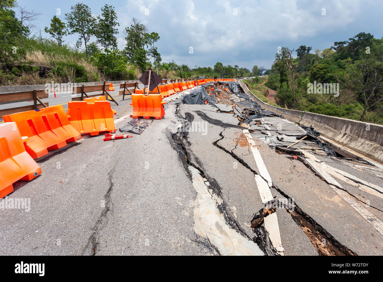 Big damage of asphalt road on the hillside cause of heavy rain and ...