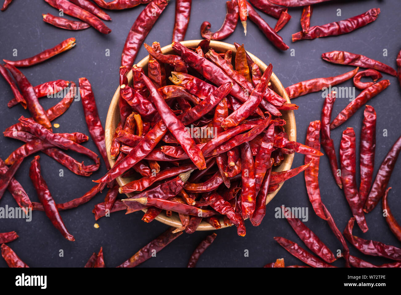 Top view dry red hot chilli on black stone board background Stock Photo ...
