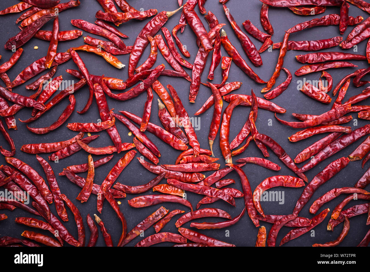 Top view dry red hot chilli on black stone board background Stock Photo ...