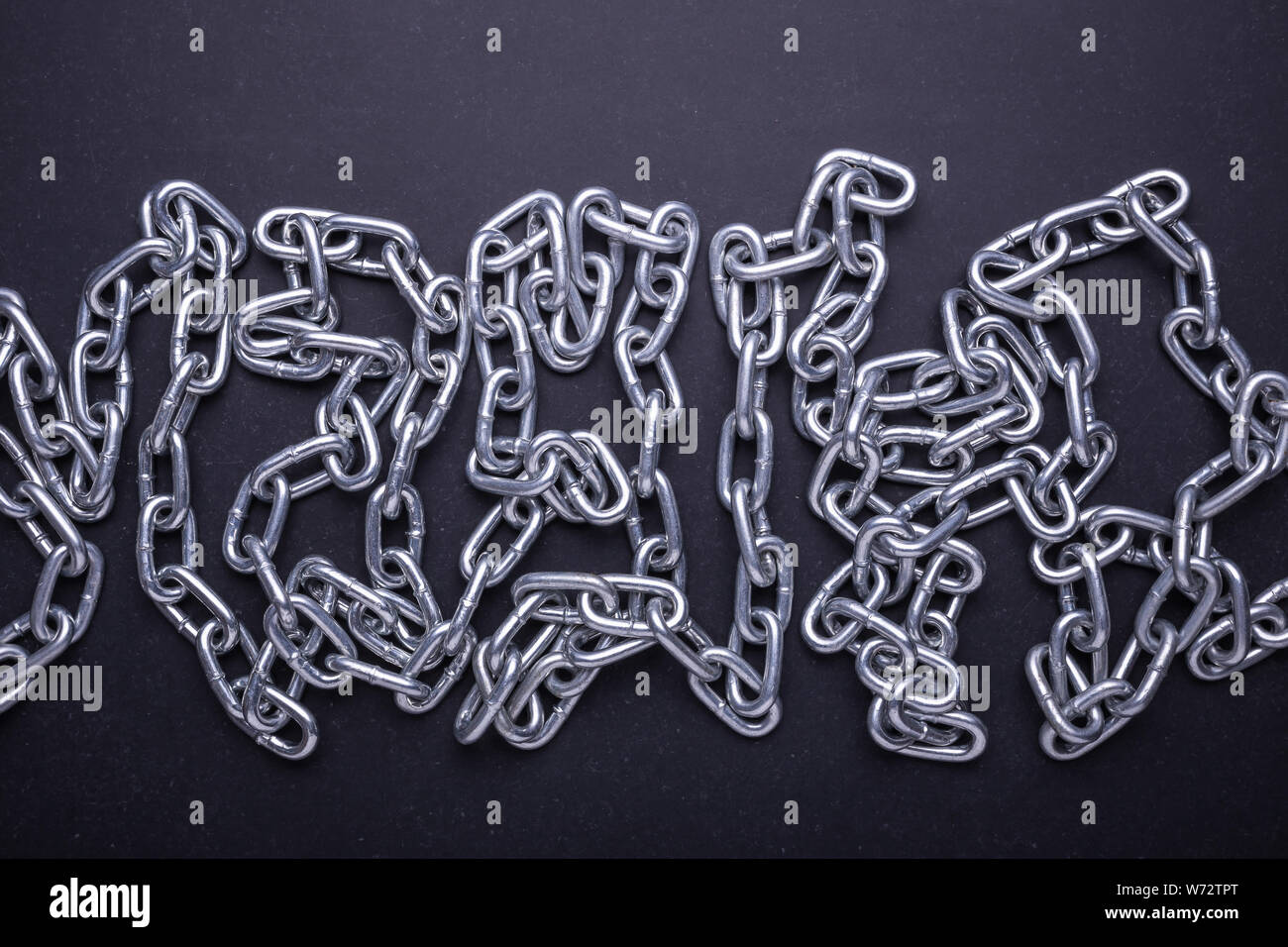 New silver metal chain. Top view on black stone background Stock Photo ...