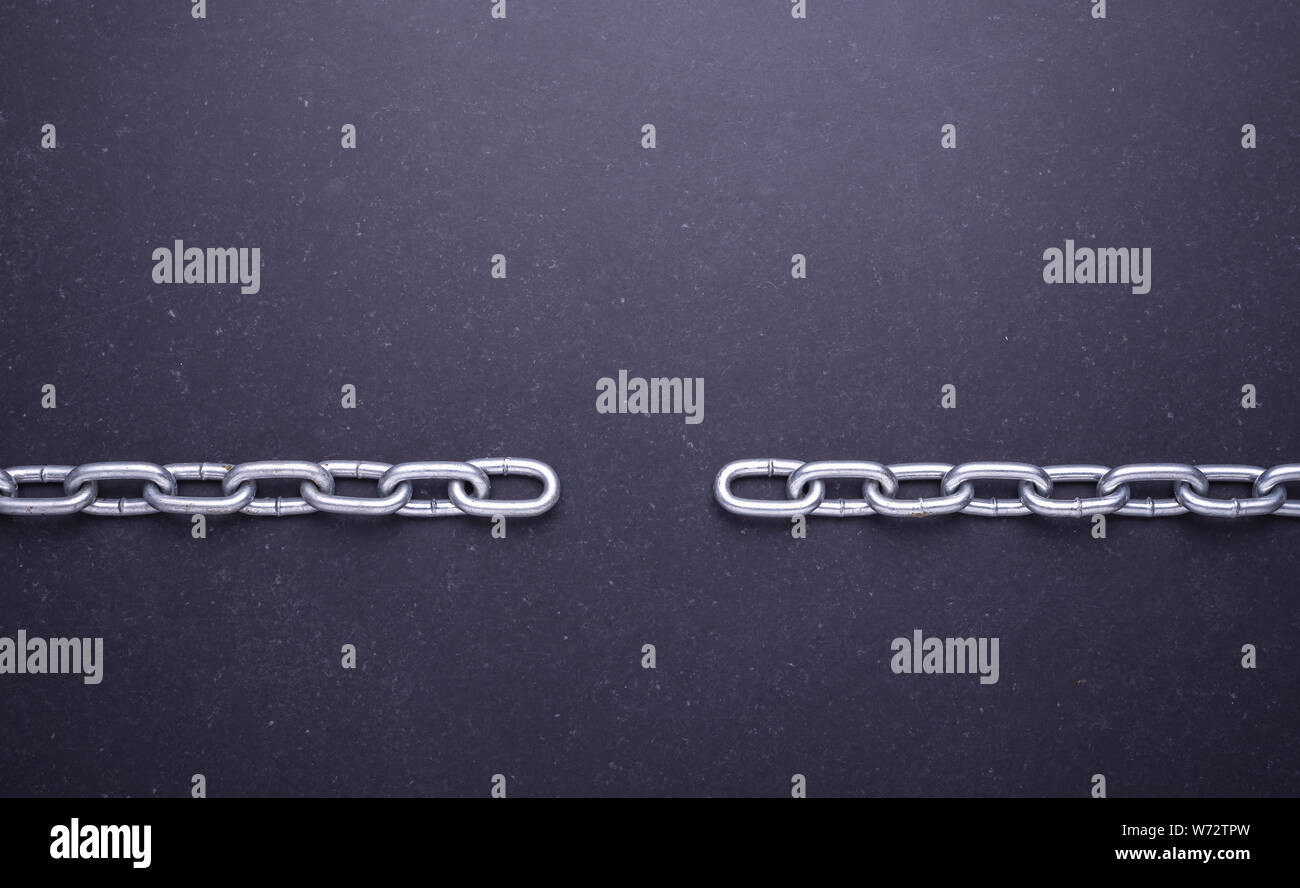 New silver metal chain. Top view on black stone background Stock Photo ...