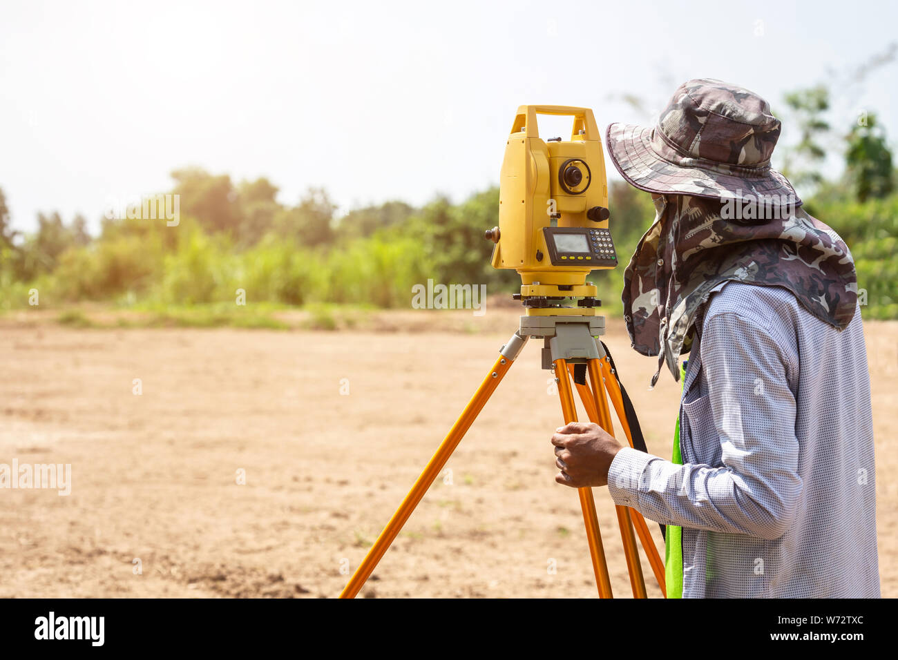 Land checking : Surveyor engineer making measure at the land Stock ...