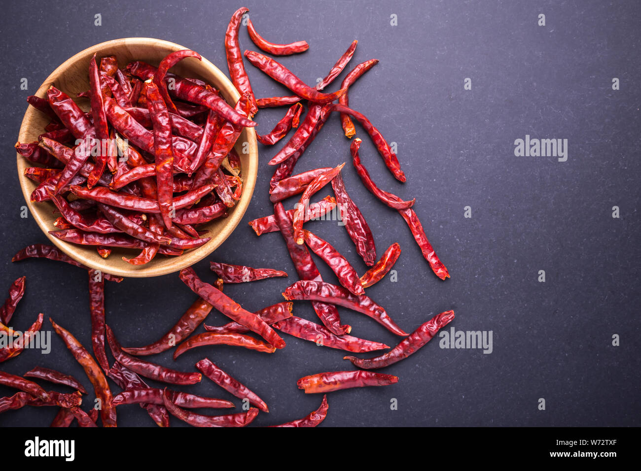Top view dry red hot chilli on black stone board background Stock Photo ...