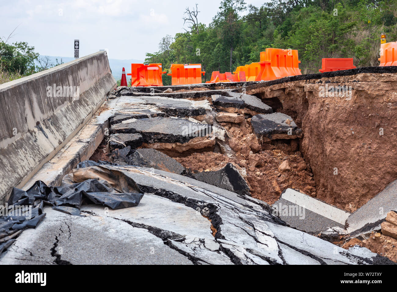 Big damage of asphalt road on the hillside cause of heavy rain and ...