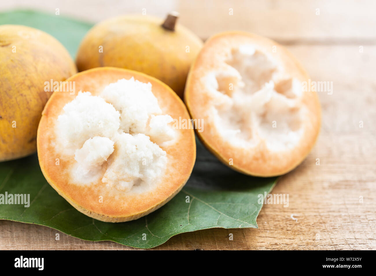 Close up Santol tropical fruit on wooden table and with green blur ...