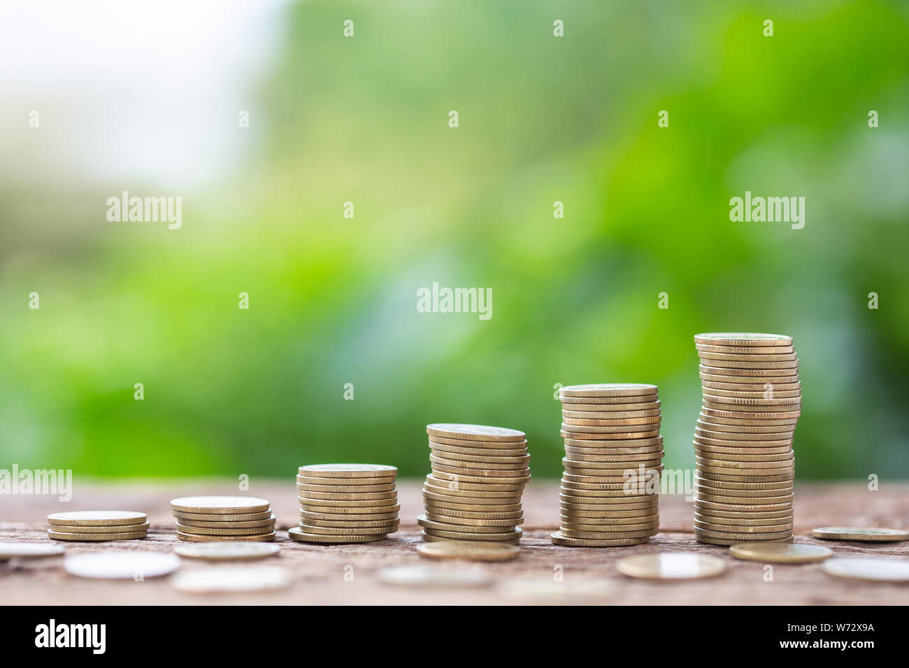 Different level of coin stack on blur background. Business success or ...