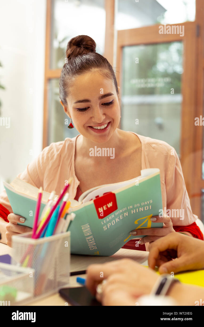 Cute brunette girl learning new words in Hindi Stock Photo - Alamy
