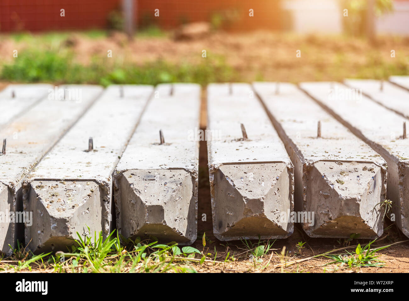 Construction worker unloading concrete stake from truck in construction ...