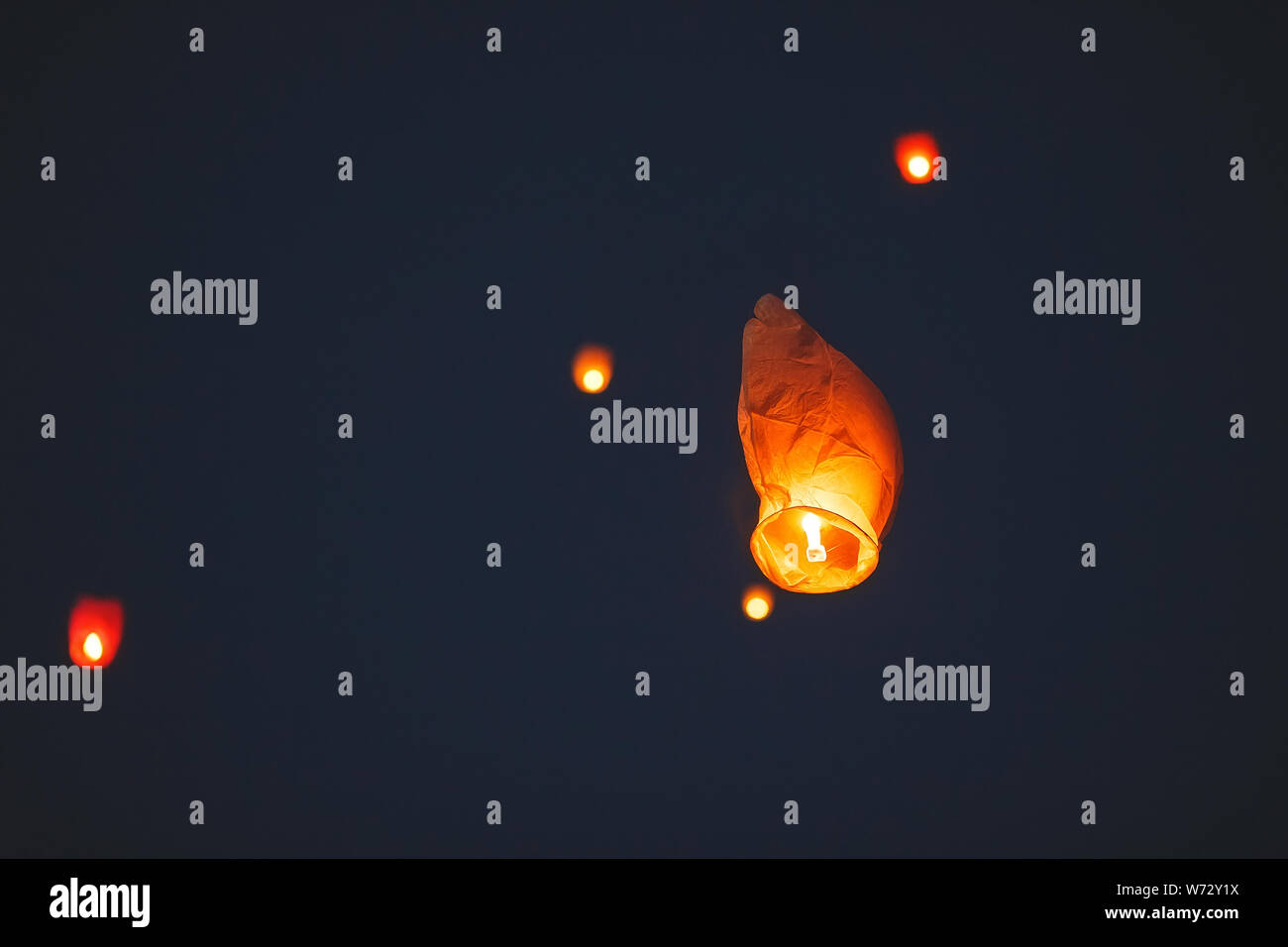 Flying lantern in the dark sky at night Stock Photo - Alamy