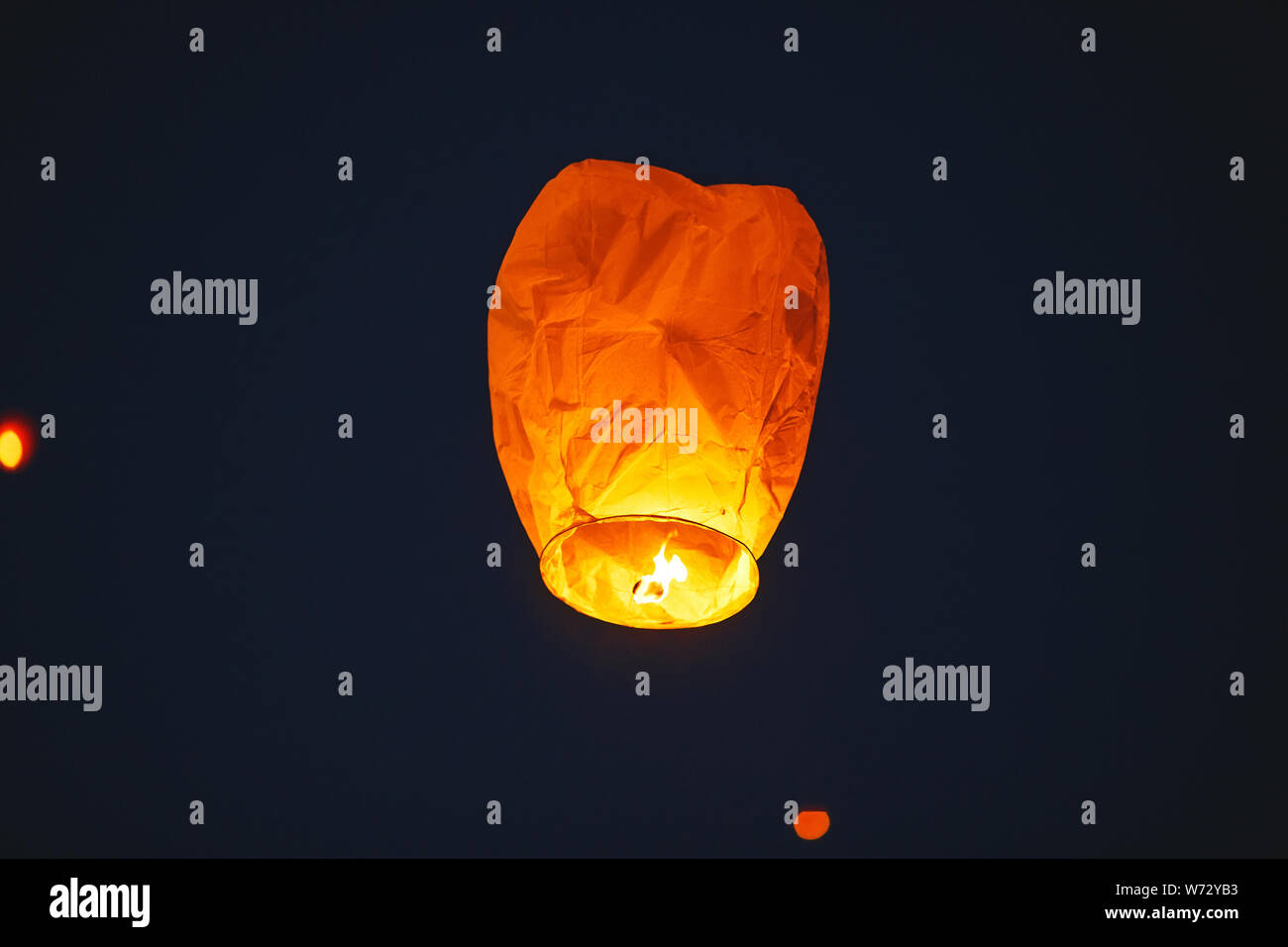 Flying lantern in the dark sky at night Stock Photo - Alamy