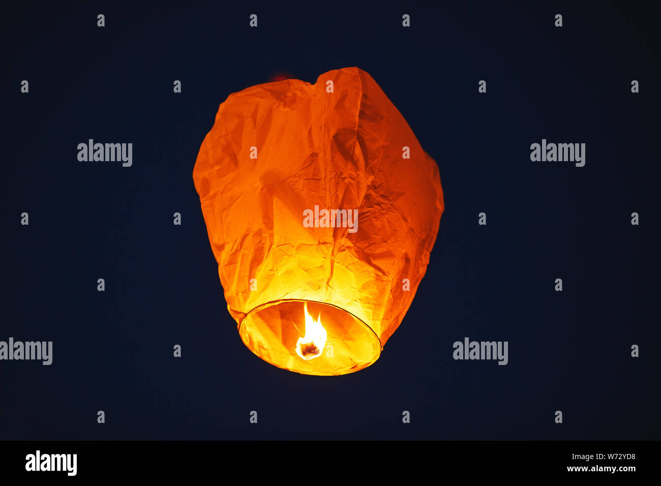 Flying lantern in the dark sky at night Stock Photo - Alamy