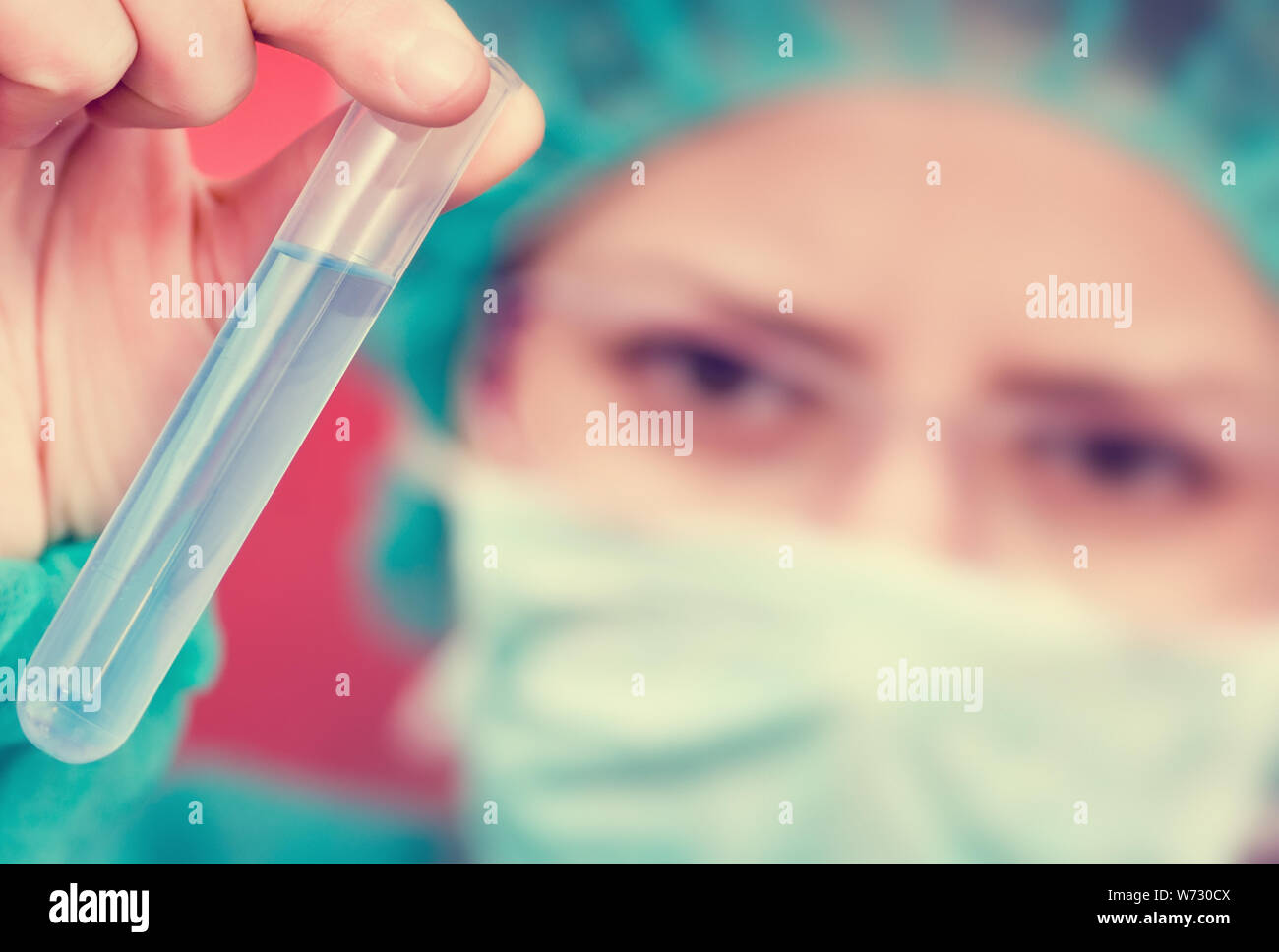 Doctor holding flask full of liquid for laboratory analysis Stock Photo ...