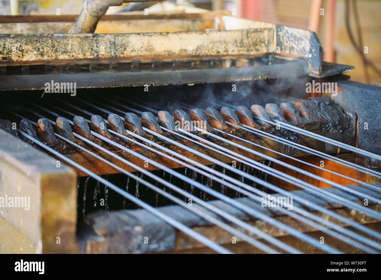 Steel wire metal feeding into bending machine in the industrial factory ...