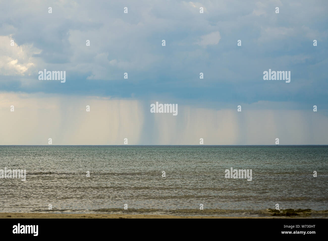 rain clouds and rain over the baltic sea Stock Photo - Alamy