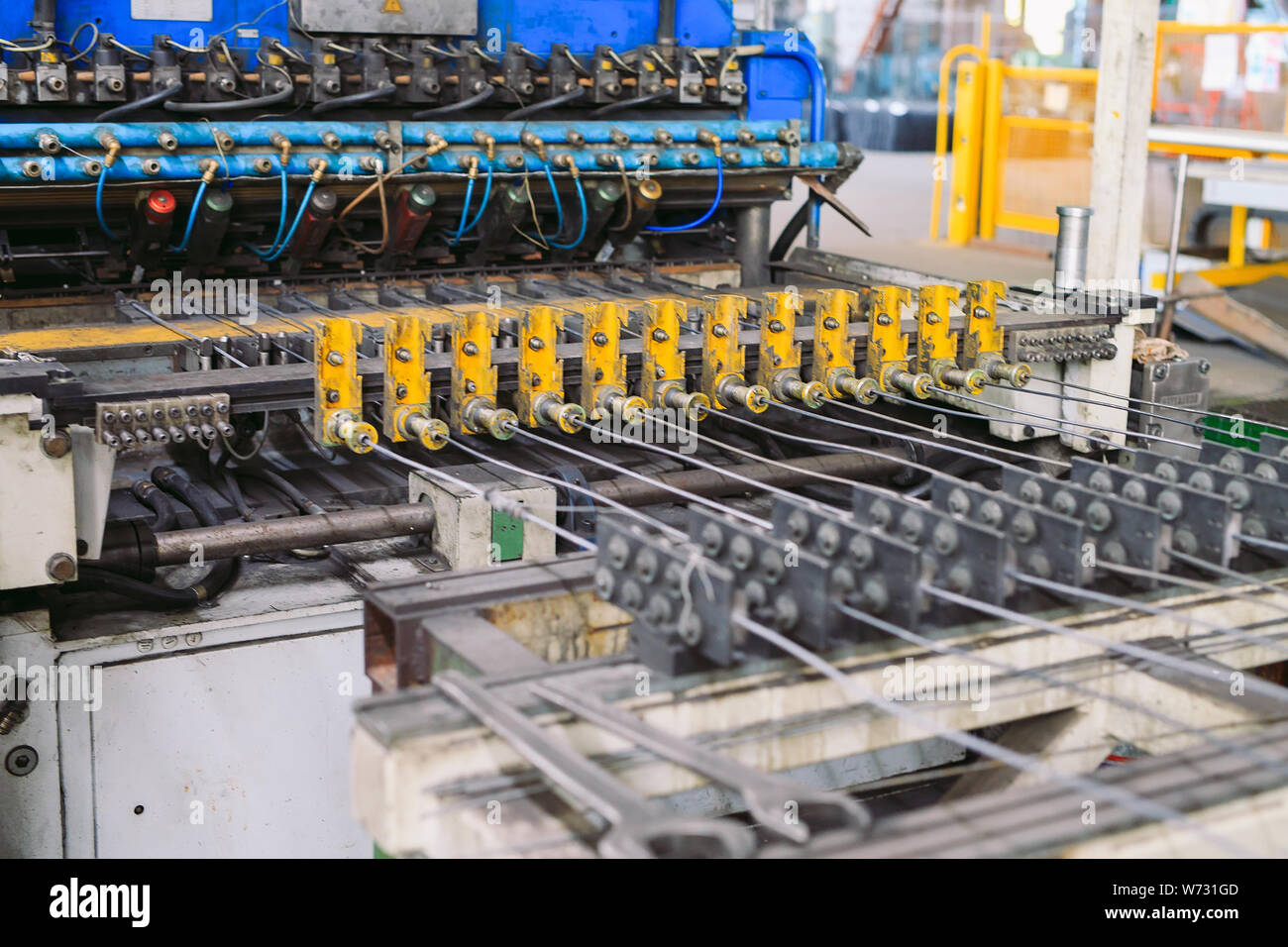 Steel wire metal feeding into bending machine in the industrial factory ...