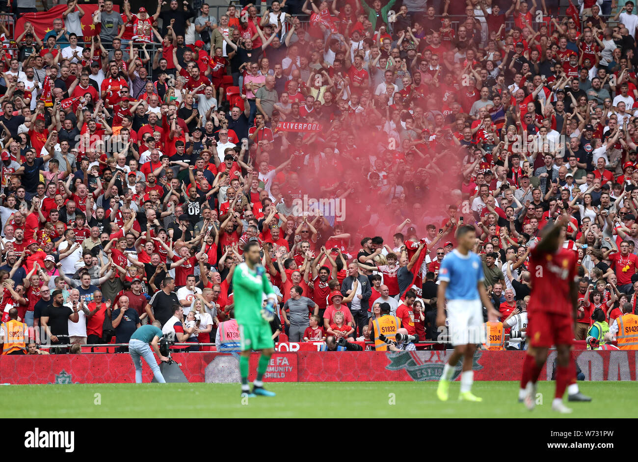 Liverpool fans set off a flare in the stands during the Community ...