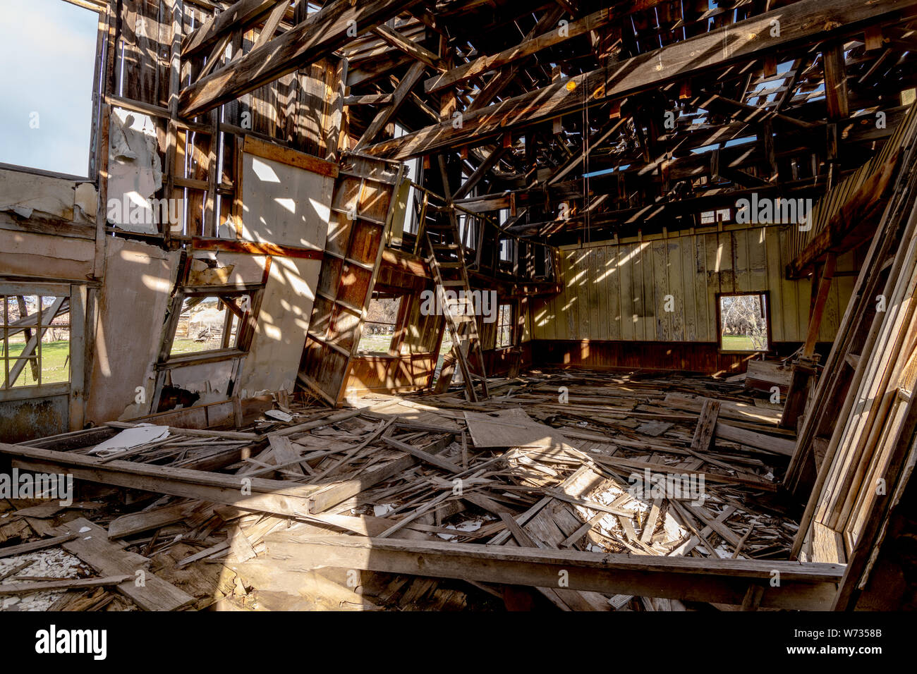 Pieces of wood fallen from ceiling and walls crumbling in an old ...