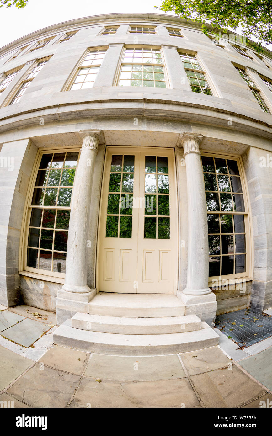 Entrance to an old building closeup with window reflections of trees ...