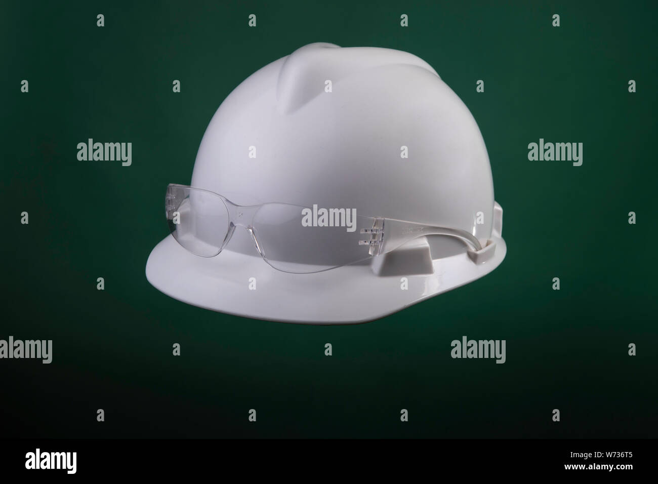 White generic protective construction helmet with a plastic transparent ...