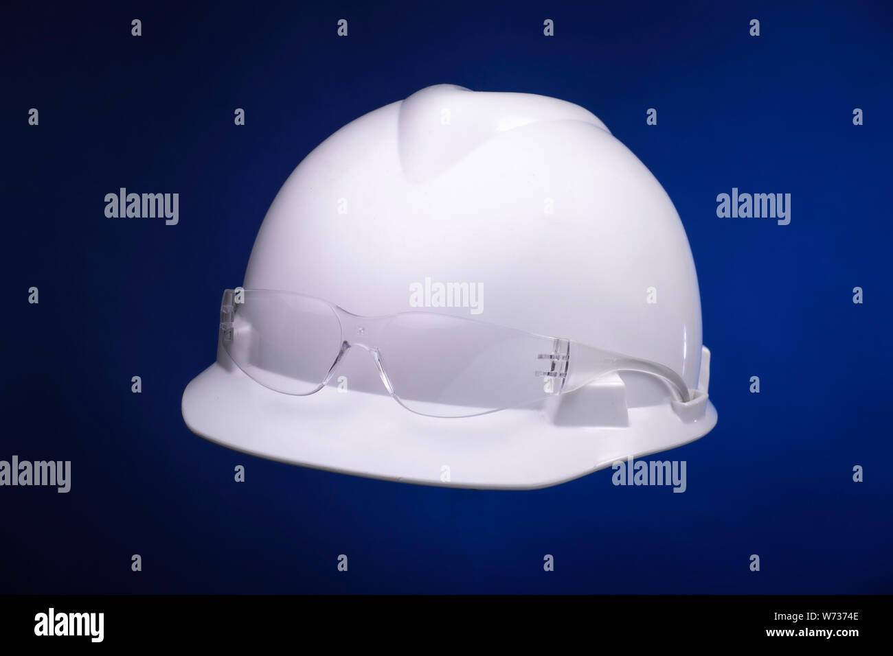 White generic protective construction helmet with a plastic transparent ...