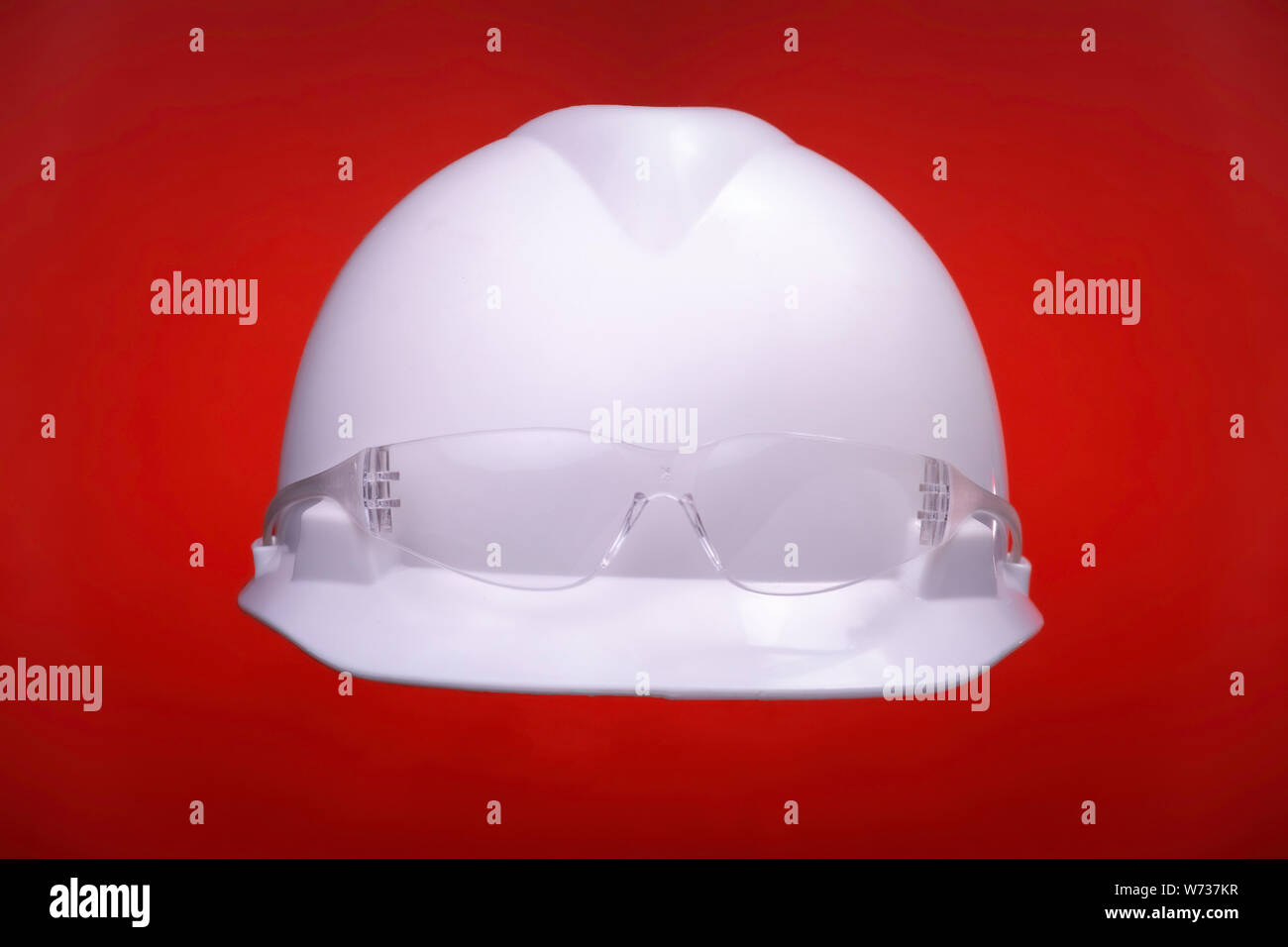 White generic protective construction helmet with a plastic transparent ...