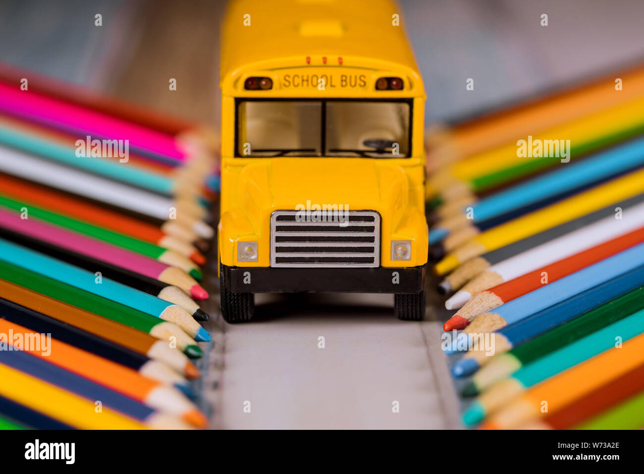 Colored pencils and toy yellow school bus, back to school Stock Photo ...