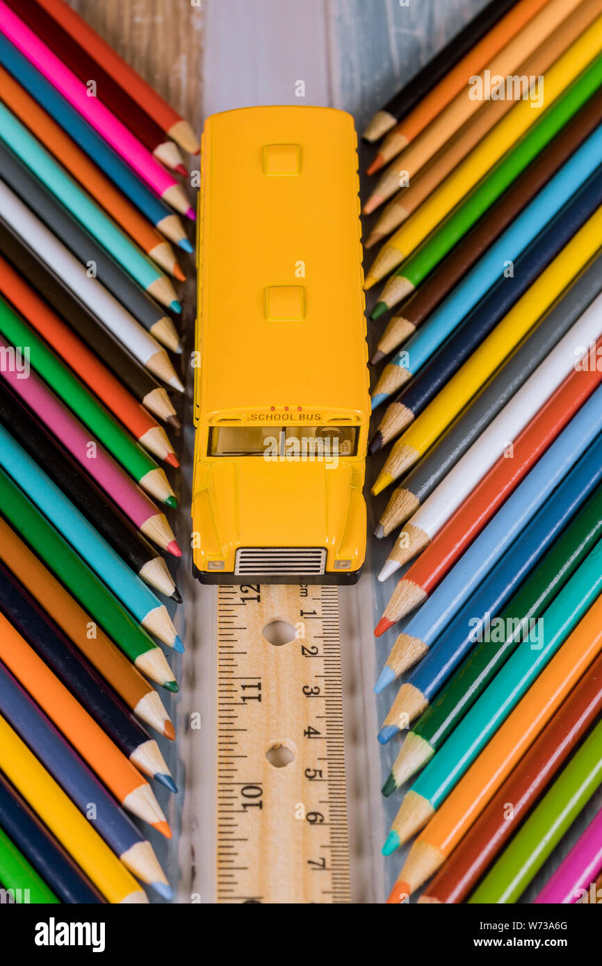 Back to school concept .School bus on ruler and colored pencils Stock ...