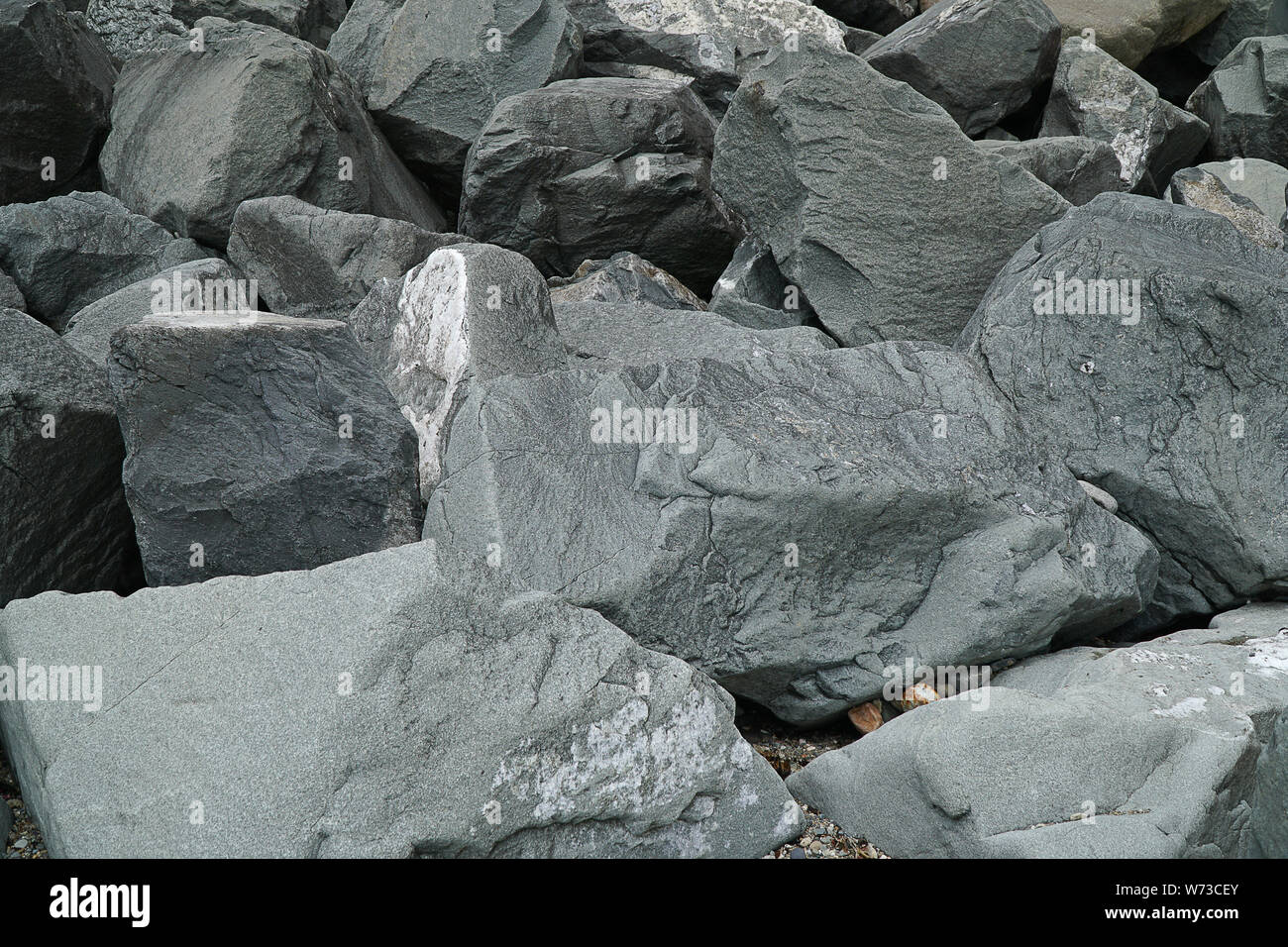 Large boulders forming a sea wall and providing protection from sea ...